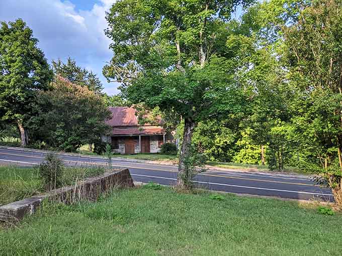 The main road curves past silent houses, inviting exploration while whispering warnings about watching your step carefully.