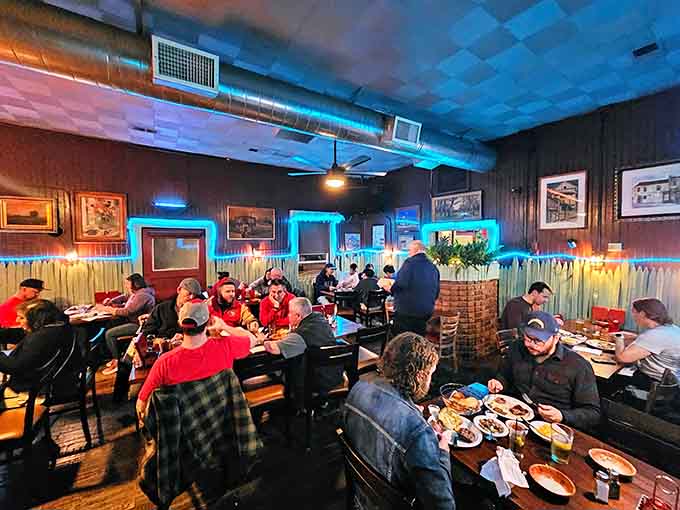 Tables full of happy diners under blue lighting, the universal sign that people have discovered something worth returning for.