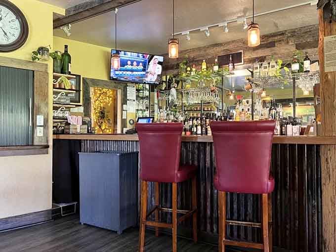 Two burgundy bar stools waiting patiently for someone to claim them and order something cold and refreshing.