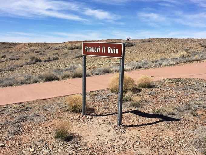 The trailhead to Homolovi II, where 1,200 rooms once buzzed with life before condos were even invented.
