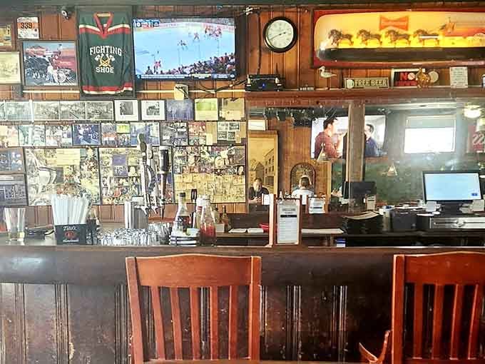 Bar stools facing shelves of memories and memorabilia, where countless conversations have solved the world's problems.