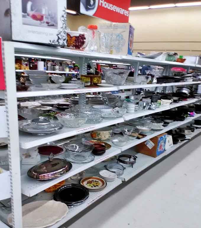 Dishware democracy where vintage Pyrex mingles with modern serving platters. That punch bowl hasn't seen action since the Reagan administration.