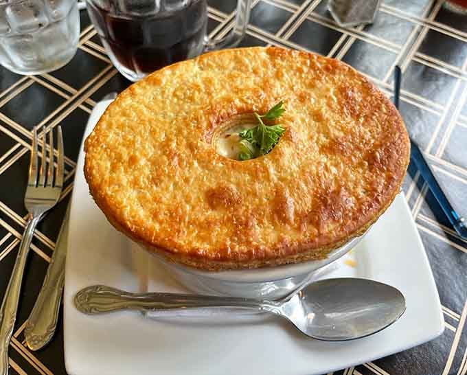 That pot pie crust rises like a golden dome of deliciousness, hiding treasures that justify every calorie.