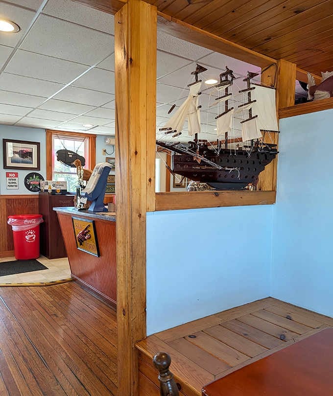 A model ship watches over diners like a guardian of maritime tradition and excellent fried clam standards.