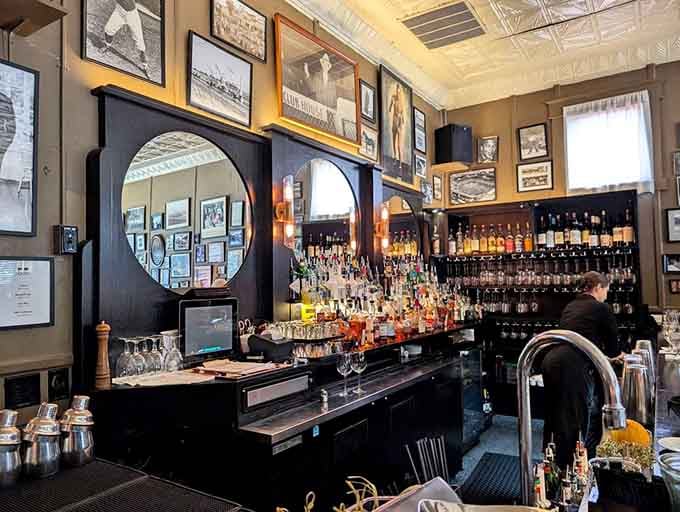 The bar gleams with bottles and circular mirrors, ready to craft cocktails that taste like Louisville decided to get fancy.