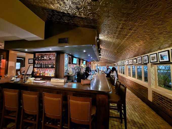 The bar area features pressed tin ceilings and enough bottle selection to make any cocktail enthusiast's heart skip a beat.