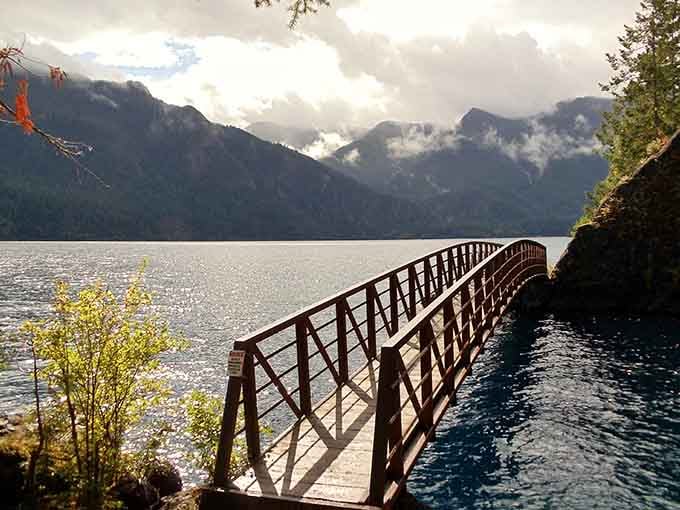 This charming footbridge over crystalline water proves that sometimes the journey really is better than the destination.
