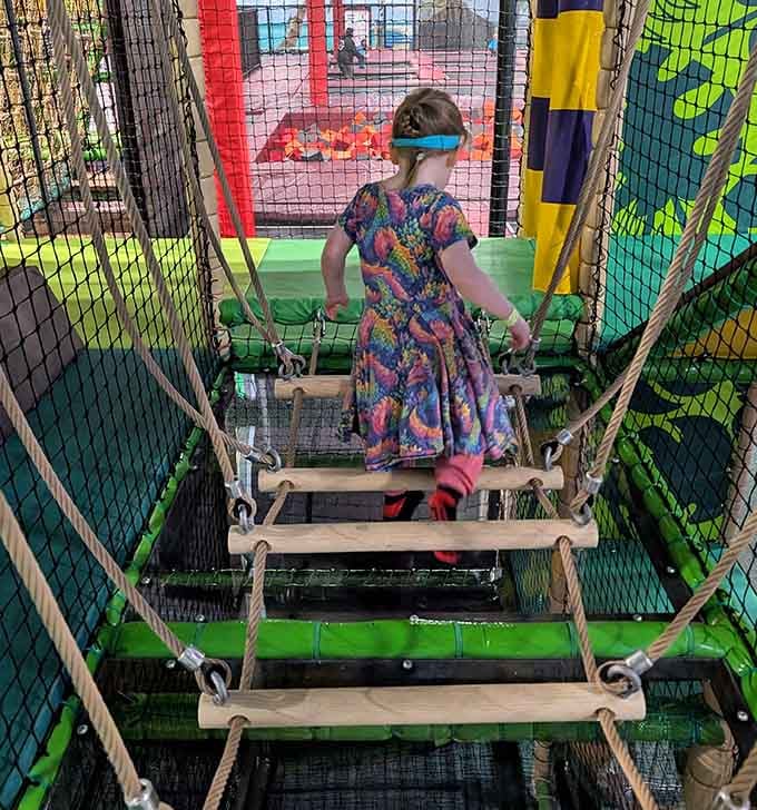 Rope bridges test balance skills while parents below contemplate their own childhood fearlessness with mild nostalgia.