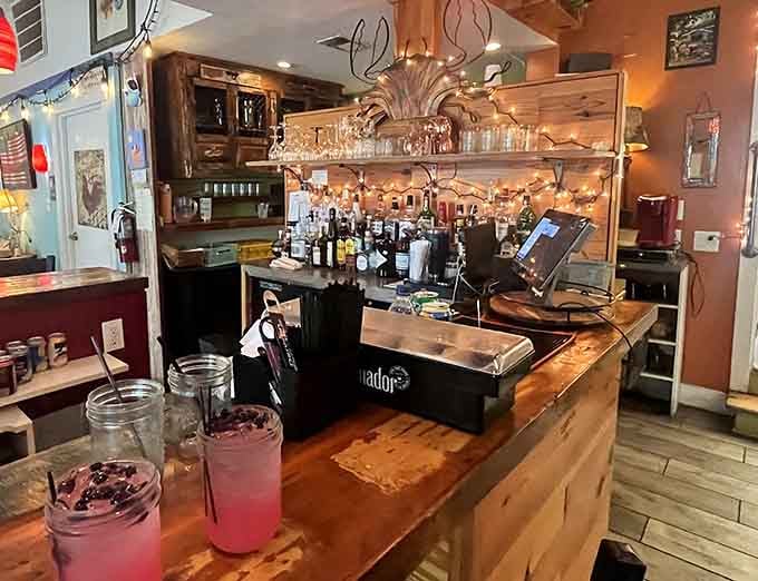The bar area decorated with twinkling lights and colorful touches, where even ordering water feels like an event.