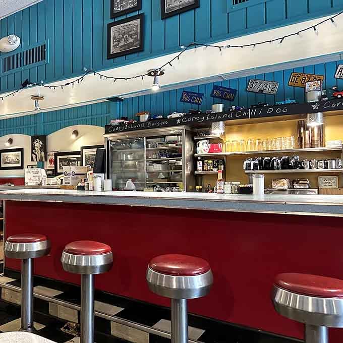 The counter with its spinning chrome stools is where the real diner magic happens, watching your breakfast come alive.