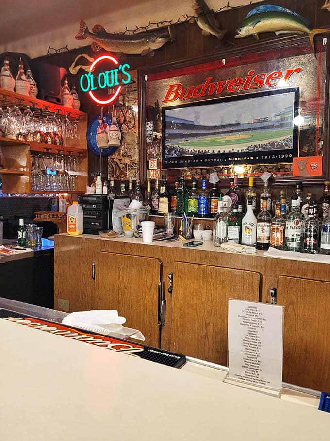 Behind the bar, bottles line up like soldiers ready for duty, backed by vintage signs and local pride.