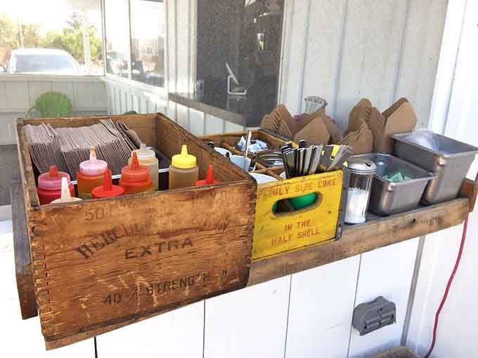Vintage wooden crates repurposed as condiment holders show more creativity than most modern restaurants' entire design concept.