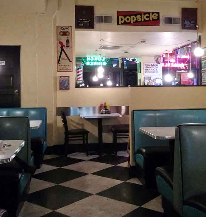 Every corner reveals another burst of retro charm, from the checkered floor to the neon glow above the booths.
