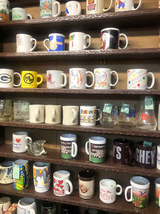 Collectible mugs spanning decades of pop culture, from Packers pride to pizza chains, each one a tiny time capsule of American nostalgia.