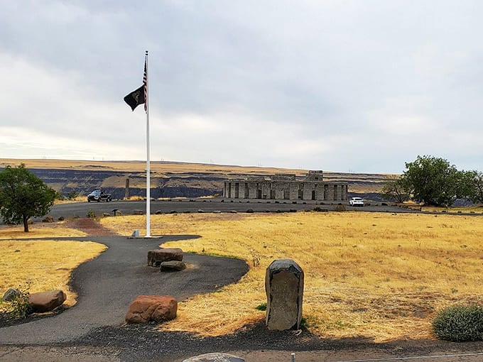 The American flag flies proudly beside this memorial, reminding visitors of its solemn purpose and meaning.