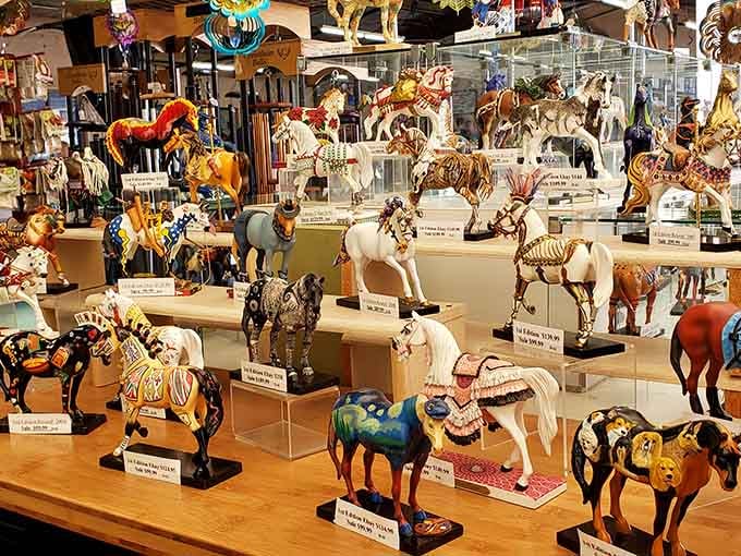 Painted horse figurines gallop across display tables in a herd of artistic creativity and Southwest charm.