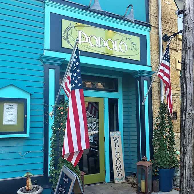Popolo's bright turquoise exterior adds a cheerful pop of color to the historic streetscape without feeling out of place.