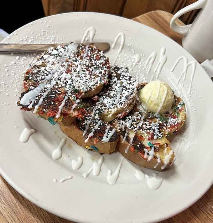 Fruity Pebbles French toast proves that childhood cereal dreams can absolutely become delicious adult breakfast realities with powdered sugar.