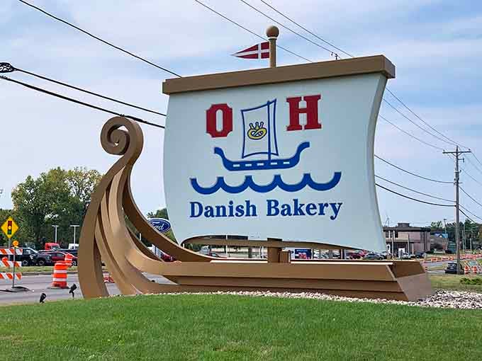 The roadside sign stands proud, beckoning travelers like a delicious lighthouse guiding ships to shore.