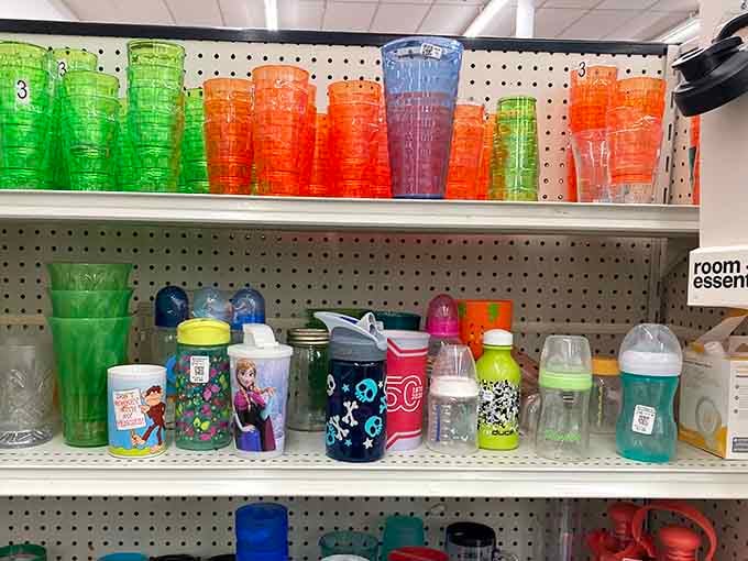Colorful drinkware lines the pegboard like a rainbow of hydration options from decades past.