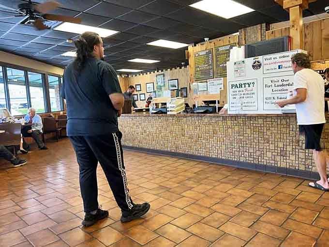 The ordering counter&mdash;where burger dreams begin their journey to reality, with staff who've mastered the choreography of fast service without sacrificing quality.