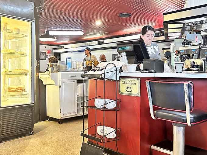 The counter area gleams with red accents and chrome details that transport you straight back to the Eisenhower era.