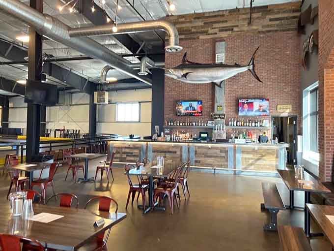 The dining space features industrial-chic design and mounted fish, because nothing says racing quite like aquatic taxidermy overhead.