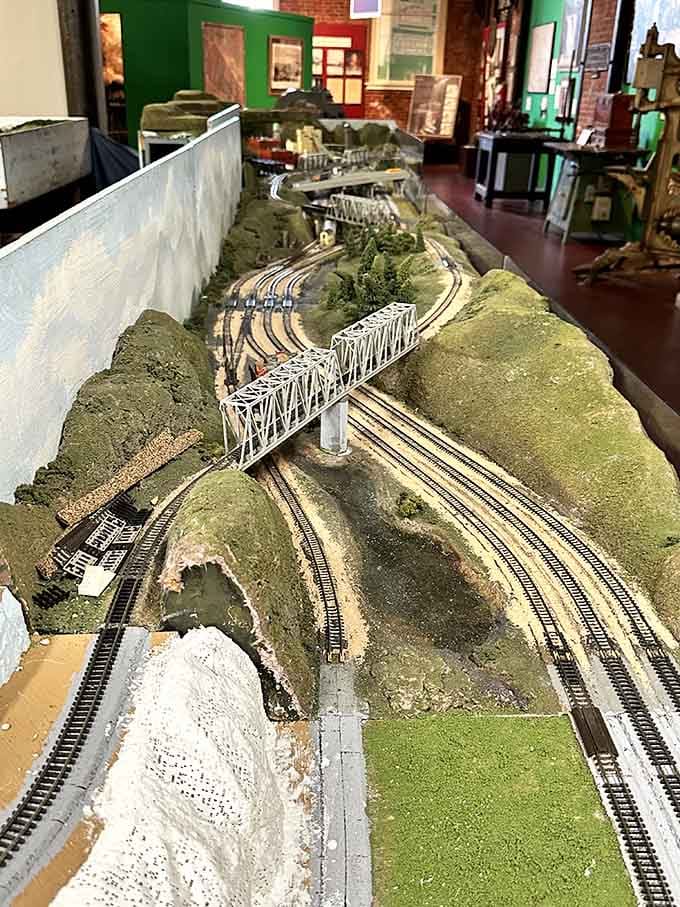 This intricate model railroad setup proves someone had serious dedication and probably excellent eyesight back then.