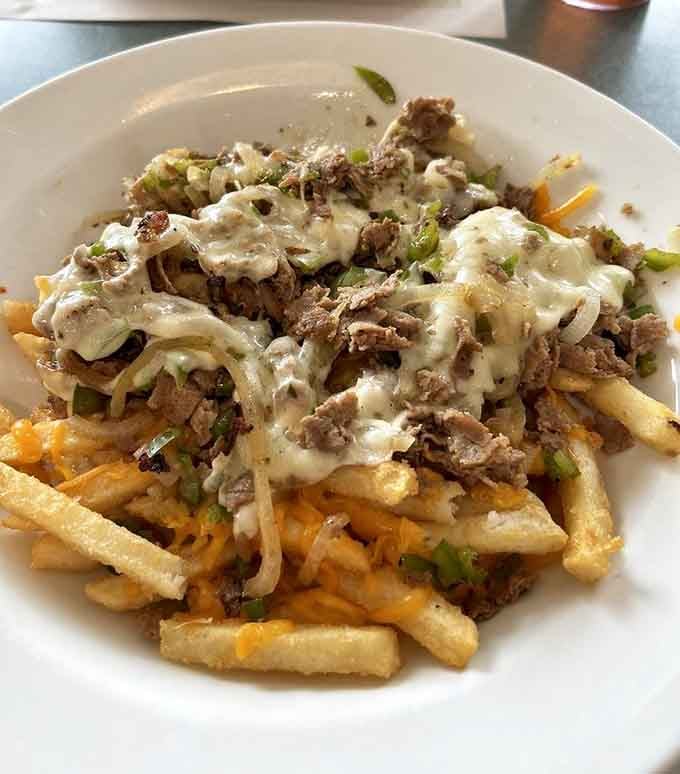 Loaded fries that blur the line between side dish and main event, topped with enough cheese to make Wisconsin jealous.