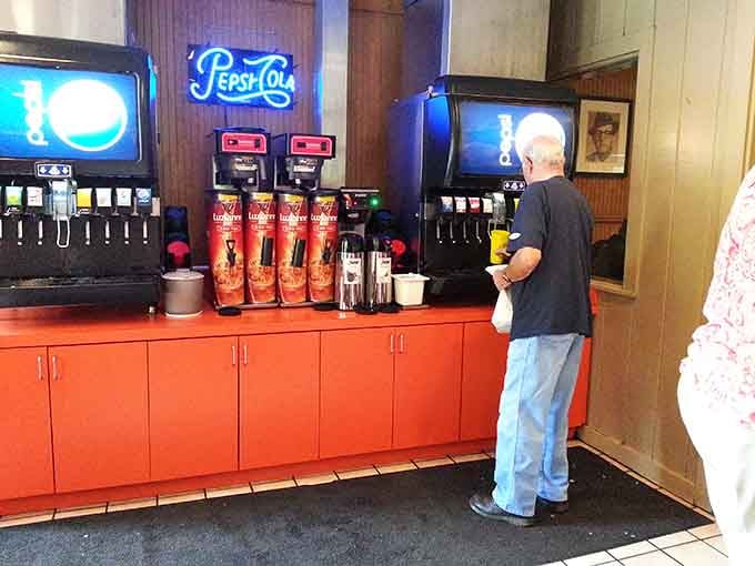 The self-serve beverage station with its bright orange counter keeps the experience casual and the refills flowing freely all meal long.