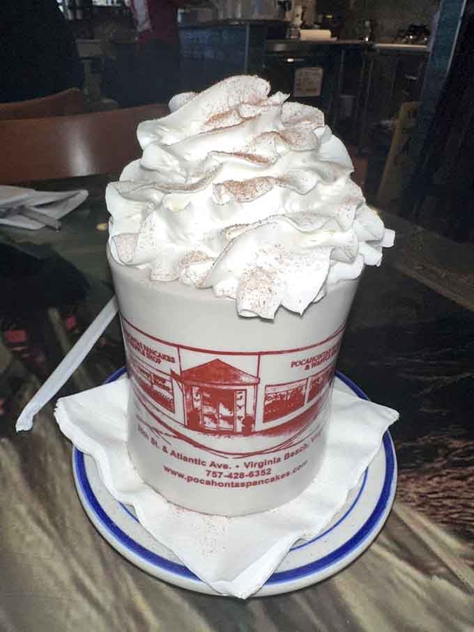 Hot chocolate so tall it needs architectural support, topped with enough whipped cream to violate several physics laws.