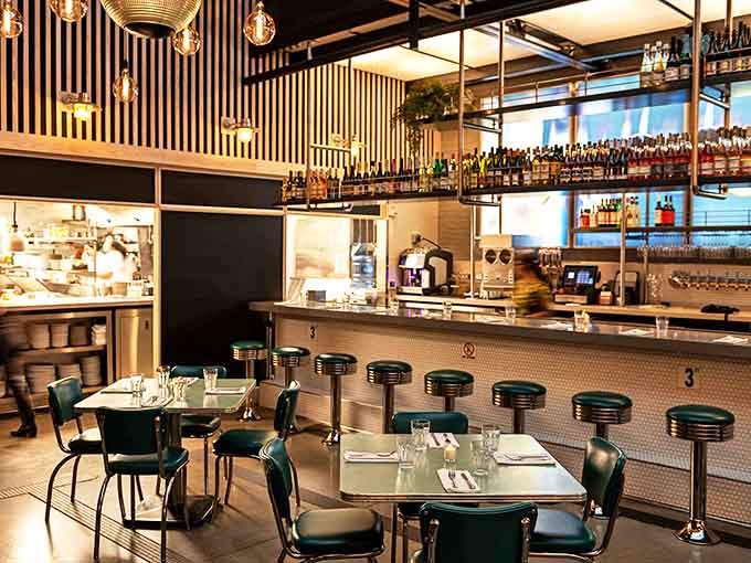 The open kitchen concept means you can watch culinary magic happen while sitting at tables that invite lingering conversations.