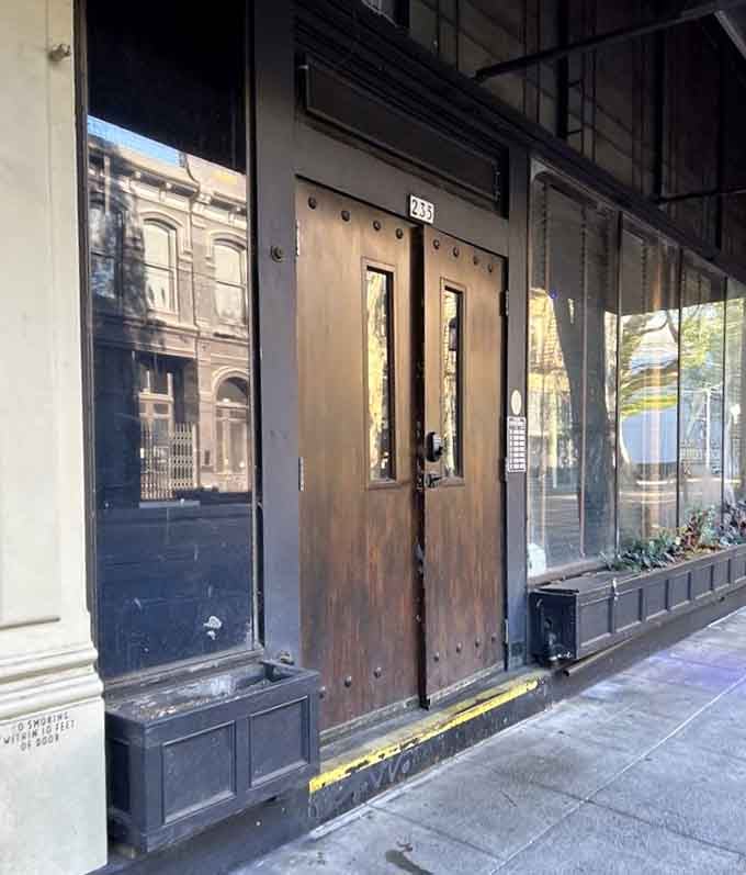 Heavy wooden doors that look like they're protecting secrets, or at least really good cocktails inside.