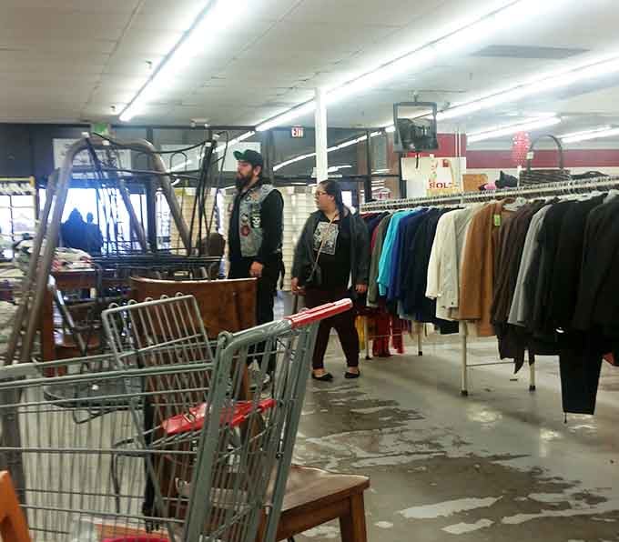 Fellow treasure hunters navigating the aisles with carts and determination, united in the universal quest for deals.