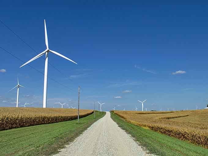 Wind turbines march across the landscape like gentle giants, powering America's first 100% wind-powered community with quiet grace.
