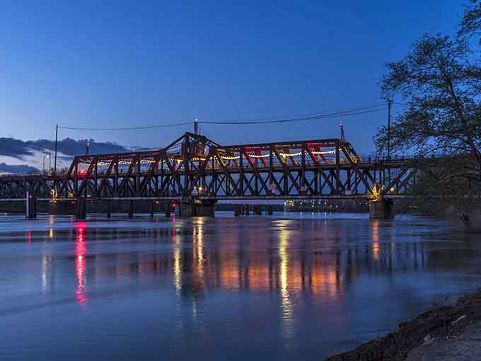 Bridge lights reflect off the water at twilight, creating a mirror image that doubles your viewing pleasure automatically and beautifully.