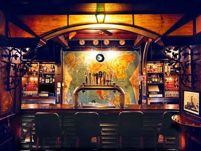 The bar area features a world map backdrop, perfect for plotting your next mission or next cocktail.