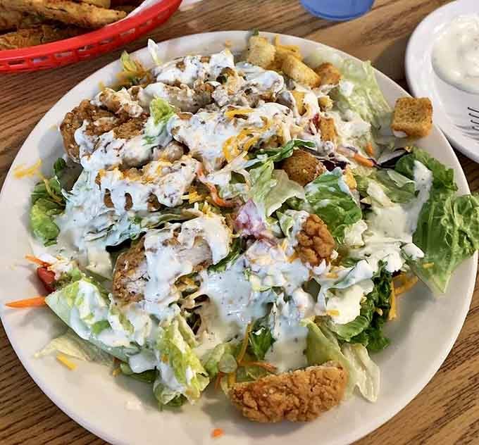 A salad that doesn't apologize for being at a BBQ joint. Crisp lettuce crowned with fried chicken proves vegetables and indulgence can peacefully coexist.