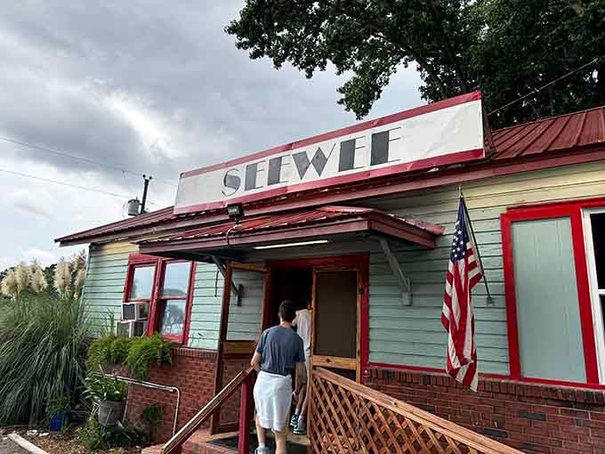 That American flag and weathered entrance tell you this place has been feeding folks right for a good long while.
