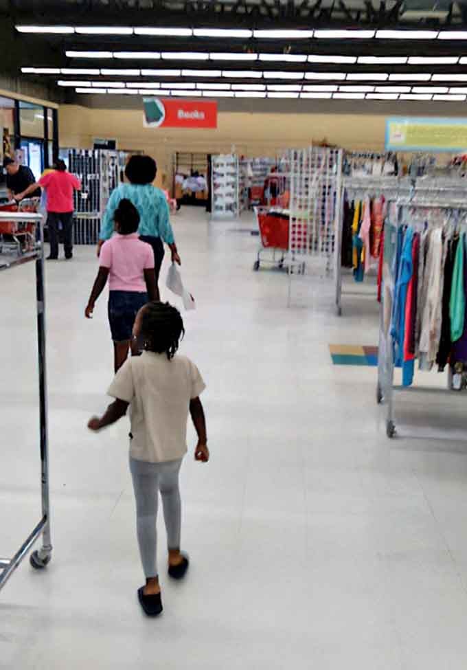 Families navigate the well-organized aisles, teaching the next generation that sustainability and smart shopping go hand in hand.