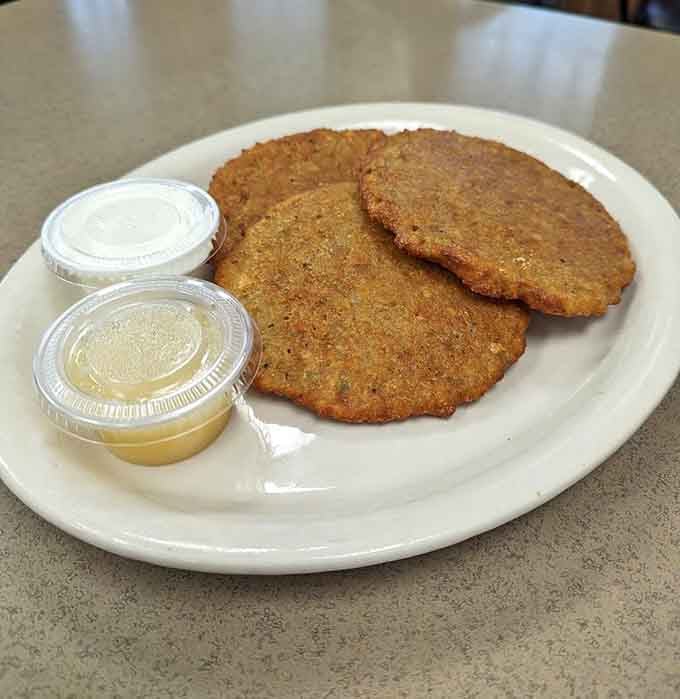 Those golden-brown potato pancakes deliver comfort food energy that would make your grandmother jealous and proud simultaneously.