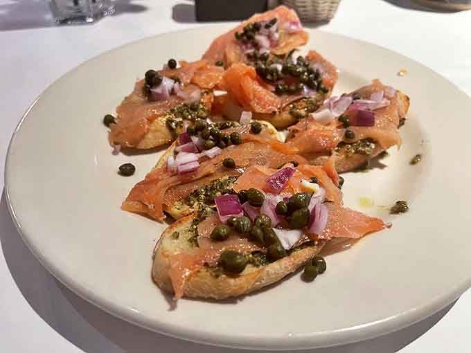 Smoked salmon bruschetta that bridges the gap between sophisticated appetizer and comfort food you'd happily eat standing over the kitchen sink at midnight.