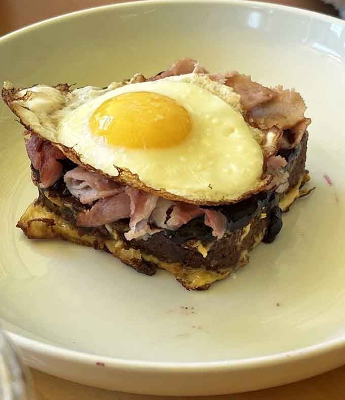 French toast topped with fruit that looks like a painting you'd hang in a museum, if museums allowed eating.