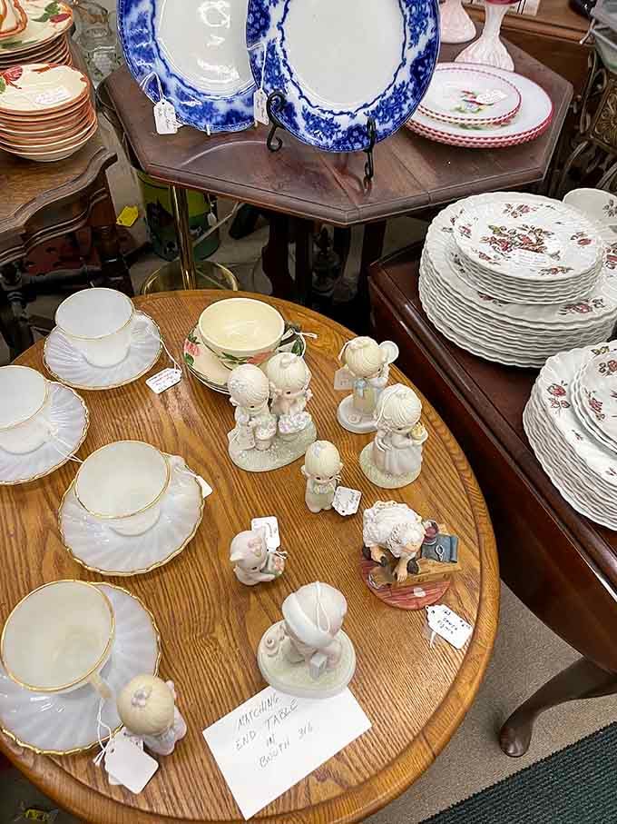 Precious Moments figurines gather around delicate china like guests at the world's tiniest tea party.