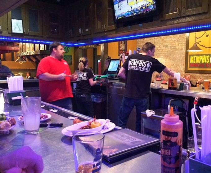The barbecue brigade in action. Dedicated staff working behind the counter to deliver championship-level flavors to eager diners&mdash;the unsung heroes of smoke and sauce.