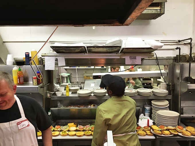 Rows of perfectly assembled burgers ready to go prove this kitchen runs like a well-oiled delicious machine.