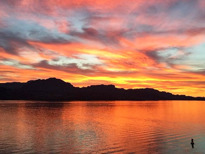 The sky puts on its nightly spectacular. Cattail Cove sunsets paint the heavens with impossible colors reflected perfectly in still waters below.