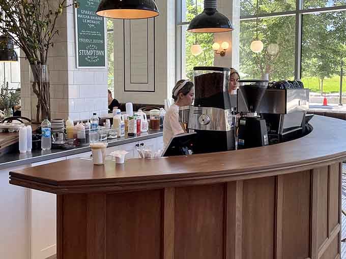 Behind that curved counter, skilled hands craft your morning fuel with the kind of care that makes waiting worthwhile.