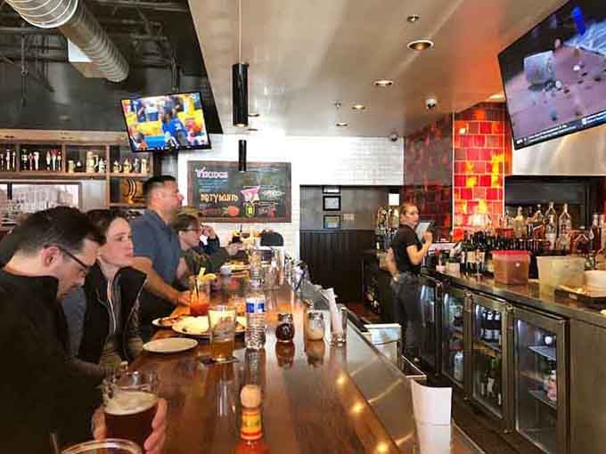The bar area buzzes with energy while TVs keep you connected to whatever game matters most this season.