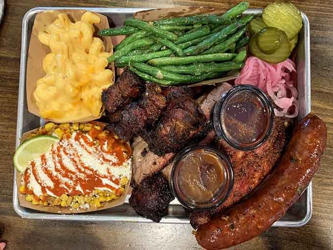 The Texas Trinity tray: brisket, ribs, and sausage with supporting actors mac and cheese, green beans, and pickles. Roll credits.